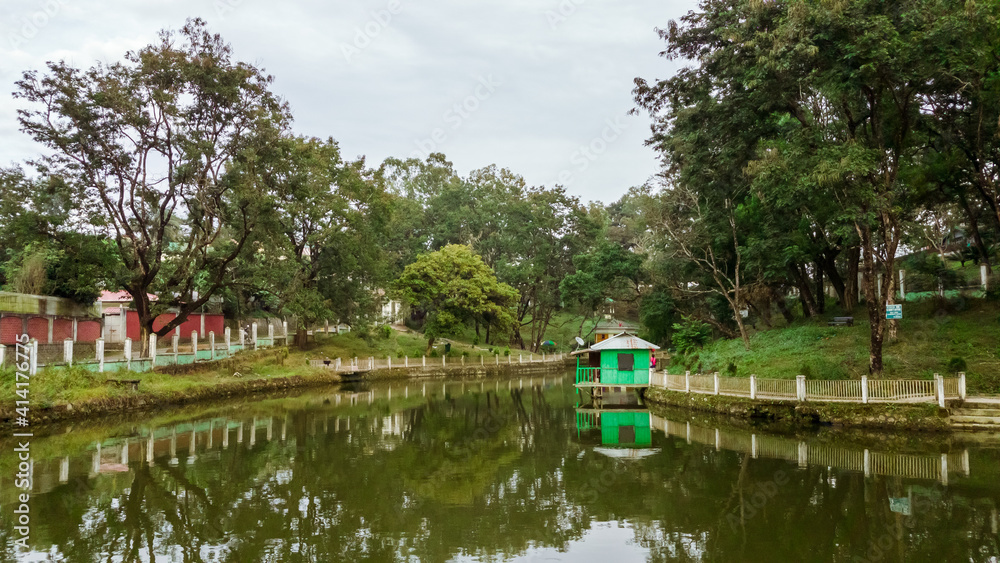 Reflections of trees in the waters of the Haflong lake in the North ...