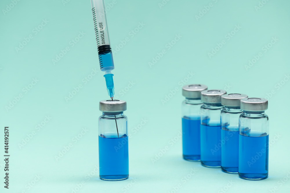 Corona Virus vaccine vials medicine bottles and syringe injection. SARS-CoV-2 Vaccination and ...