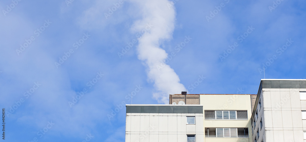 Facade of city apartments. Residential building with smoking chimney ...
