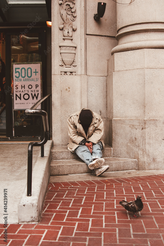 Homeless man sitting outside a luxury shopping mall, San Francisco ...