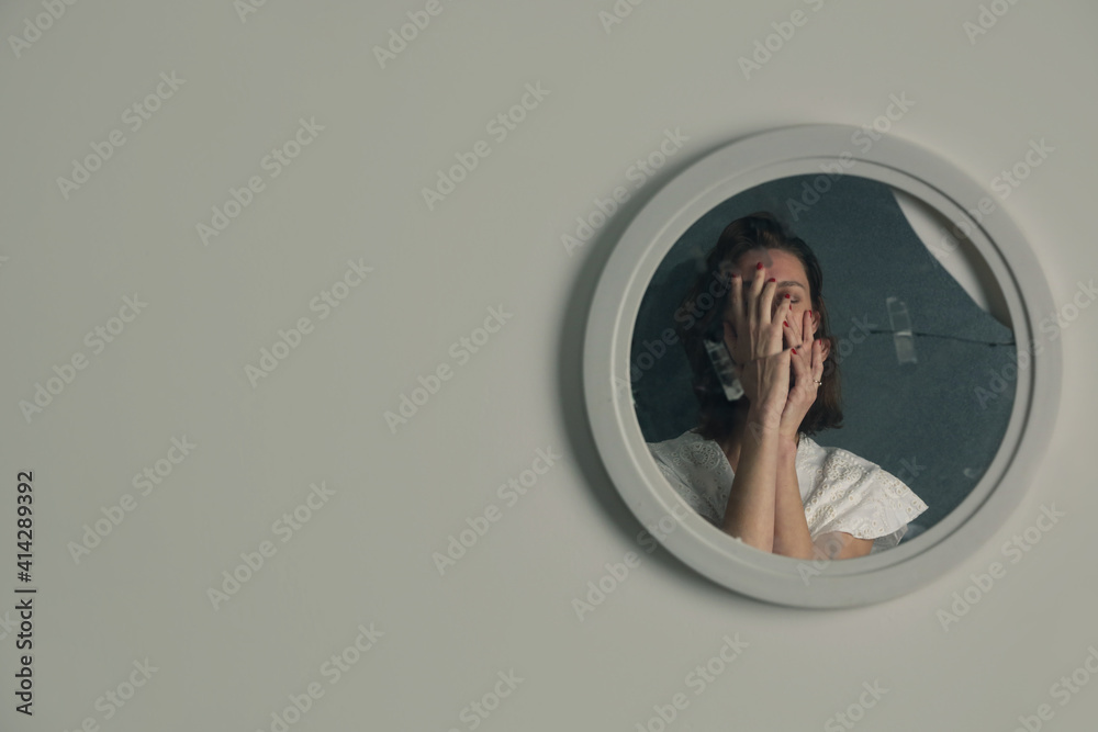 Reflection of a woman's face in broken mirror. Depression, anxiety ...