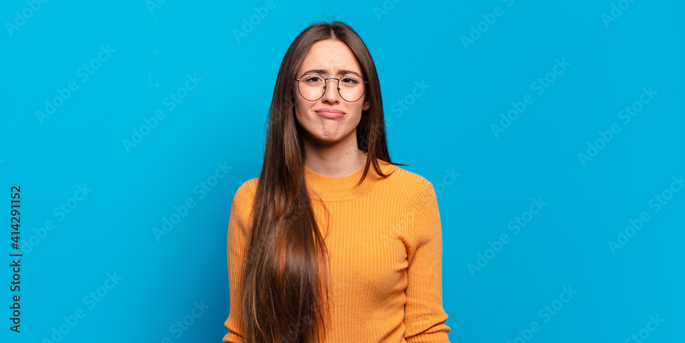 young pretty casual woman looking goofy and funny with a silly cross ...