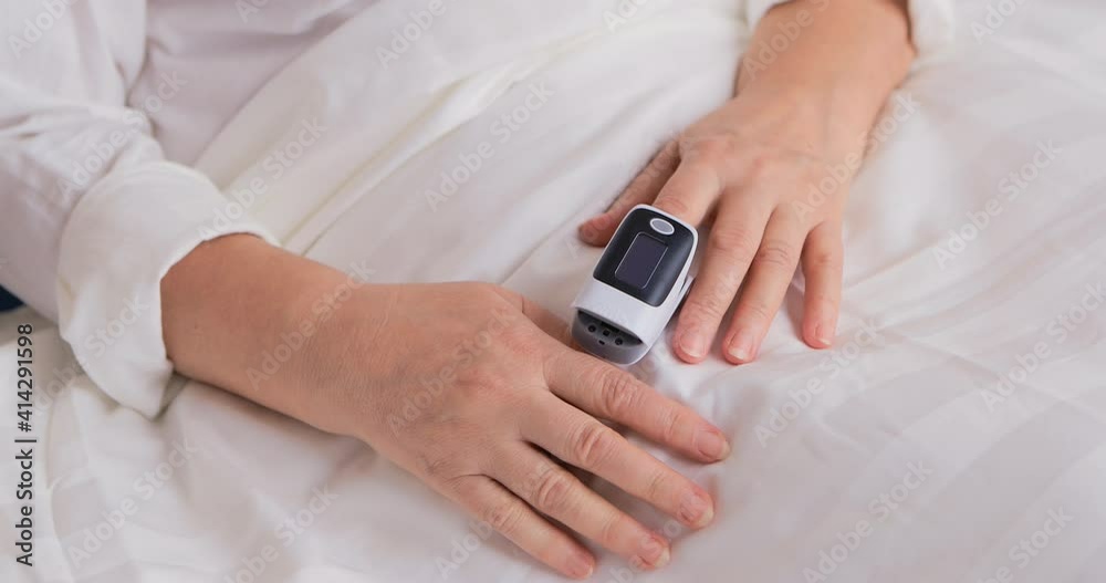 Pulse oximeter at home or clinic show oxygen saturation level in blood ...