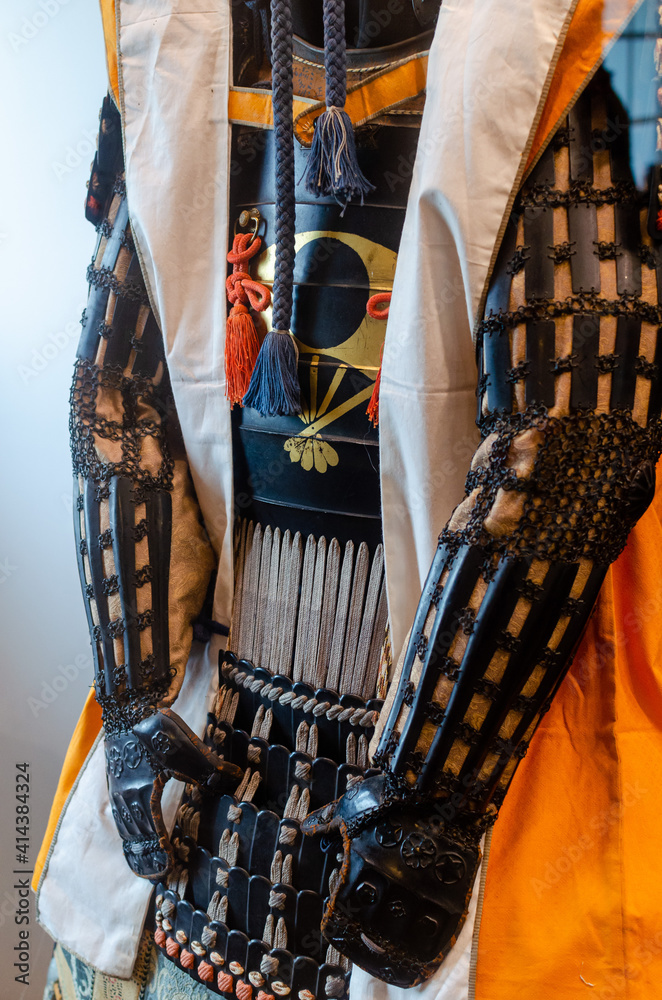 Original medieval japanese samurai armor (yoroi) in the museum. Hands ...