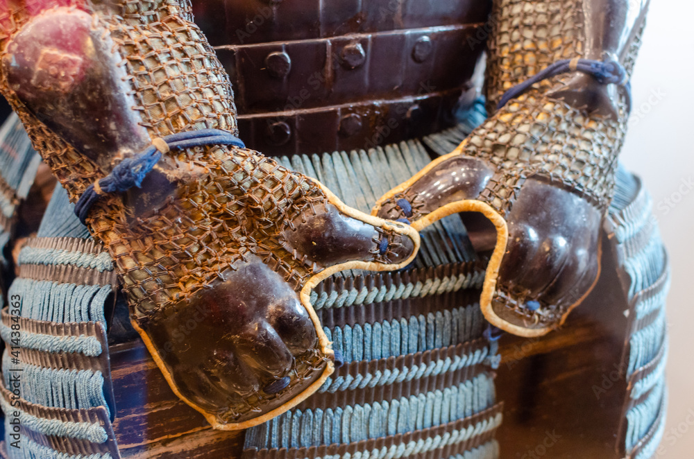 Original medieval japanese samurai armor (yoroi) in the museum. Hands ...