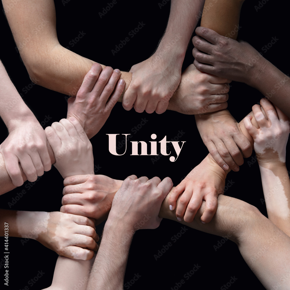 Togetherness, unity. African and caucasian hands gesturing on gray ...