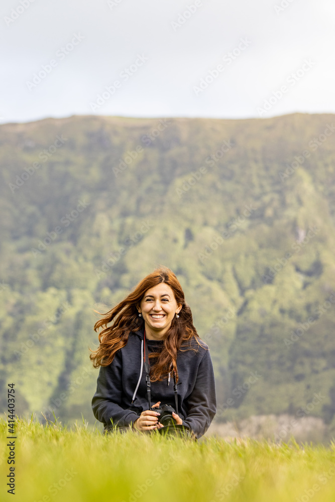 Girl sitting in grass, by Sete Cidades lake, enjoying the landscape ...