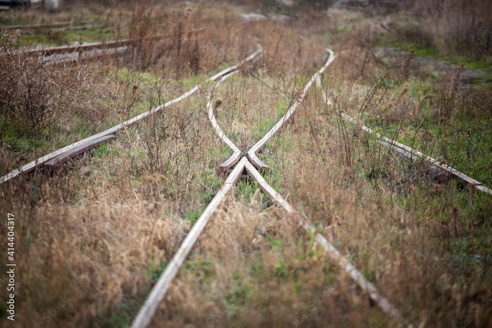 Perspective of old and rusty switch rail on an abandoned railway line ...