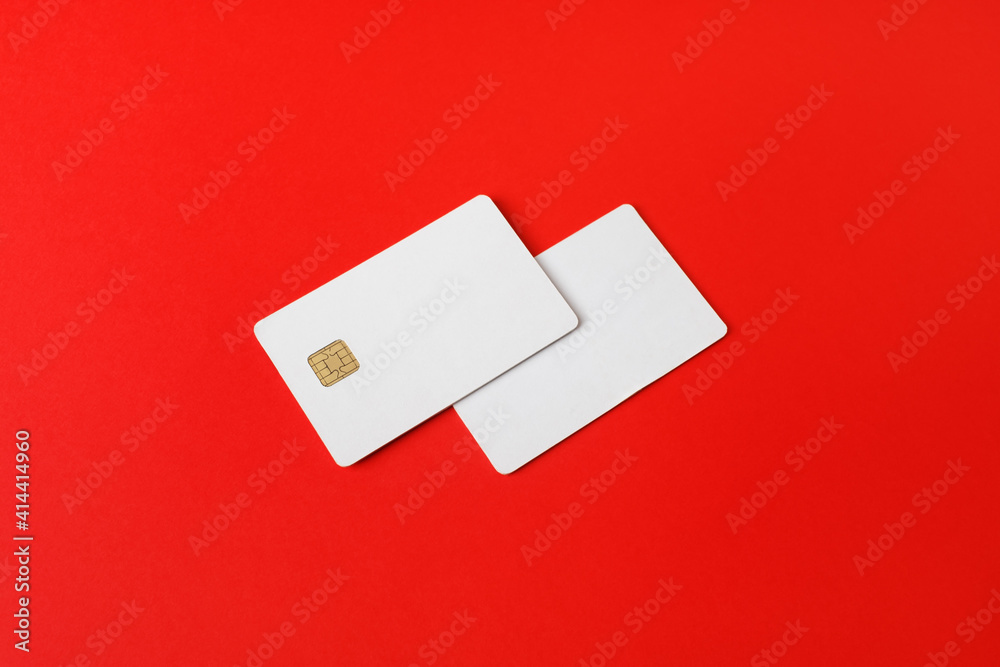 Two blank credit cards on red paper background. Photo of white bank ...