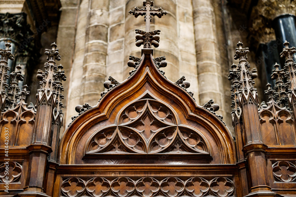 Gothic architecture. Cross on a wooden base with patterns. Prayer booth ...