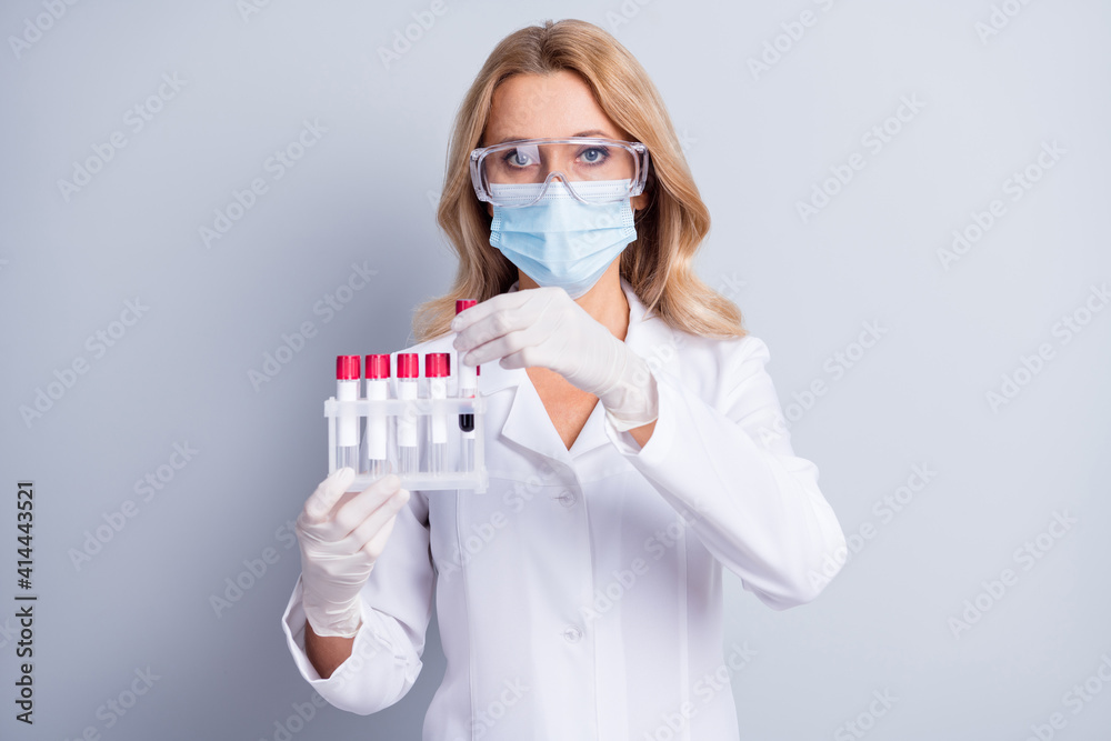 Portrait of lady nurse arms hold blood sample tubes wear safety facial ...