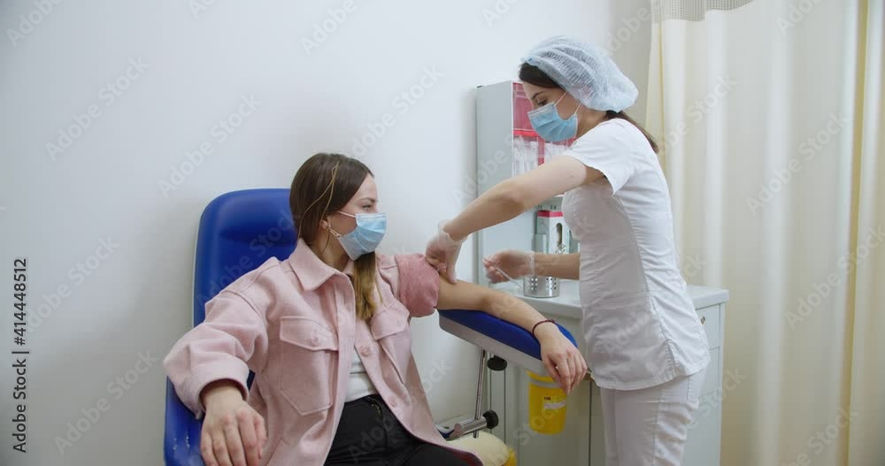 Medical Nurse in Safety Gloves and Protective Mask is Making a Vaccine ...