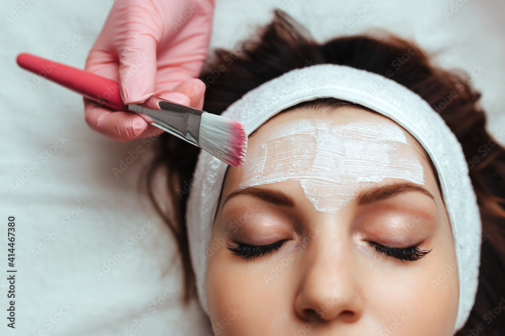 applying cream to the skin of a model in a spa salon close-up Stock ...