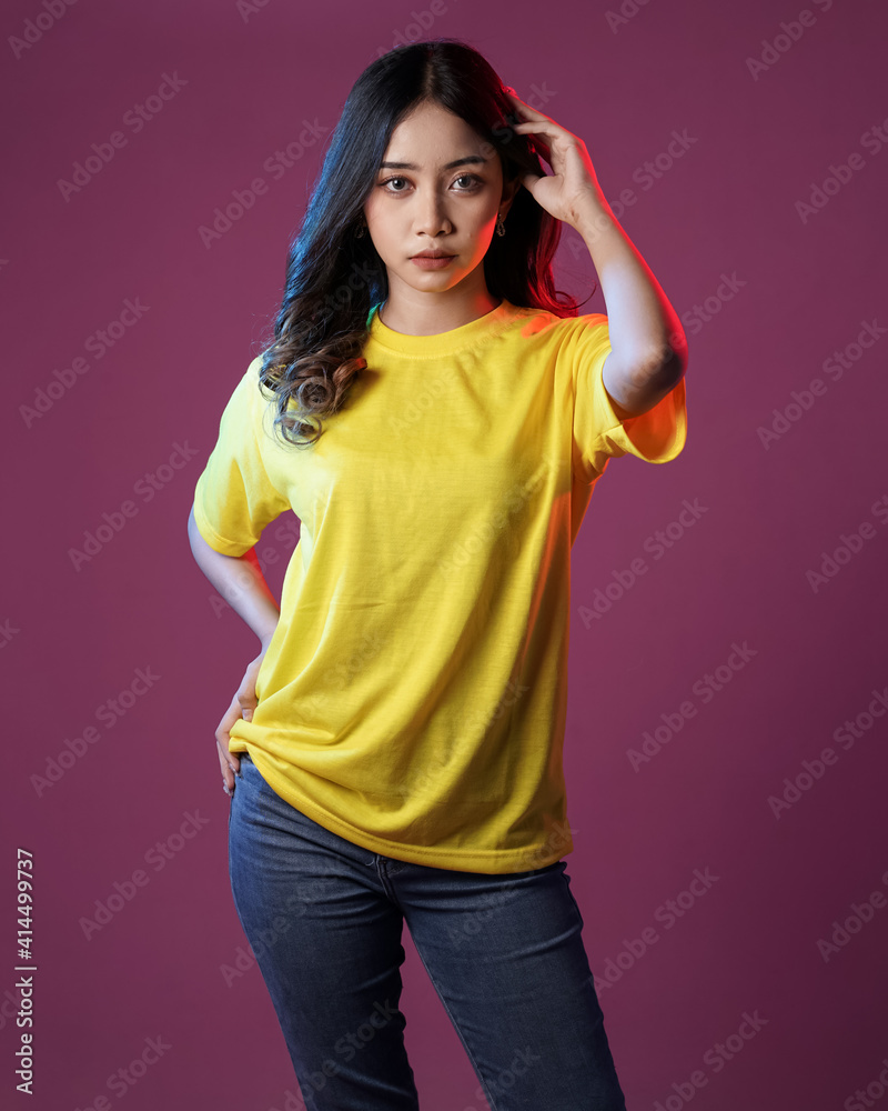 Young female model wearing blank T-shirt in studio background. Woman in ...