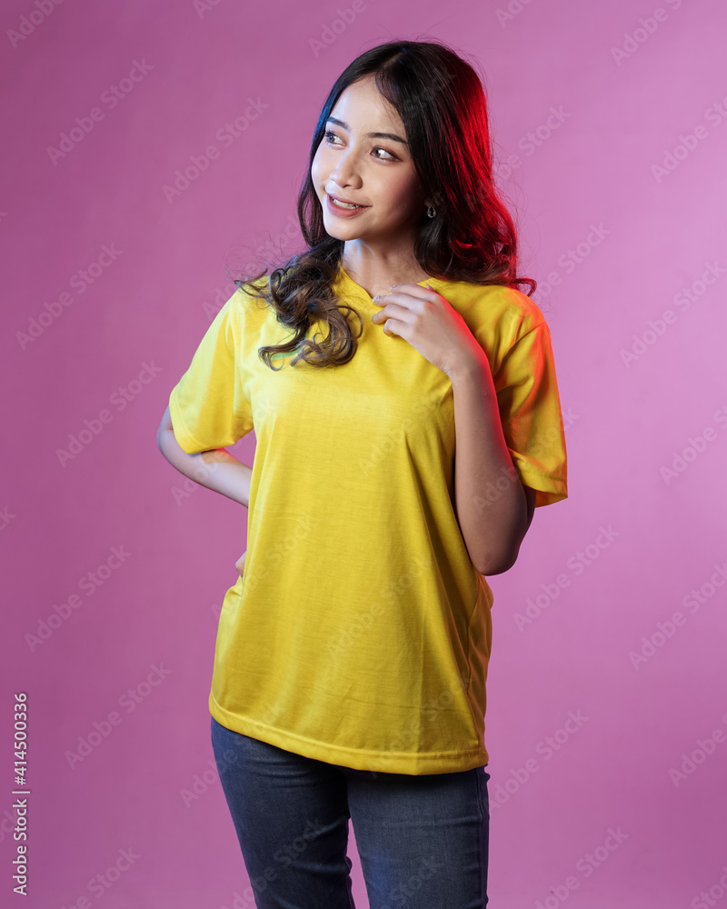 Young female model wearing blank T-shirt in studio background. Woman in ...
