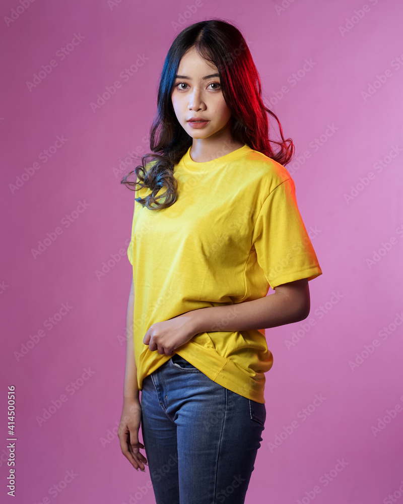Young female model wearing blank T-shirt in studio background. Woman in ...