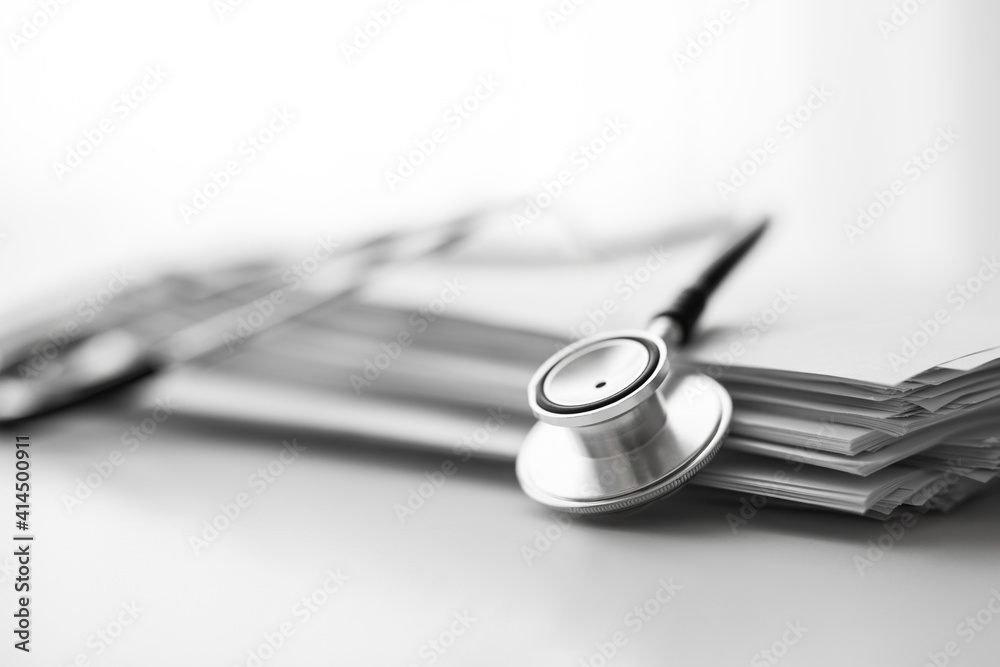 Stack of report medical documents and stethoscope isolated on white ...