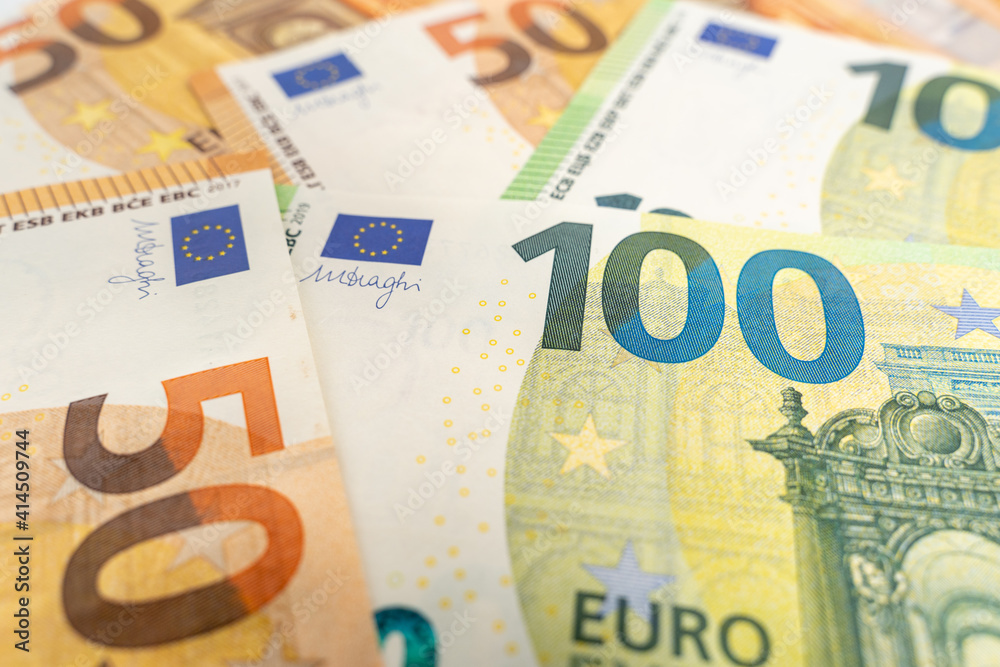 Banknotes background. Fifty and one hundred Euro notes in orange and ...