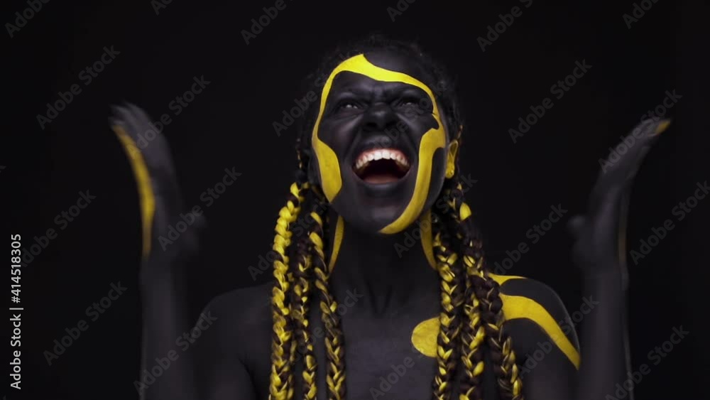 Face art. Screaming snarling wild woman with black and yellow body ...