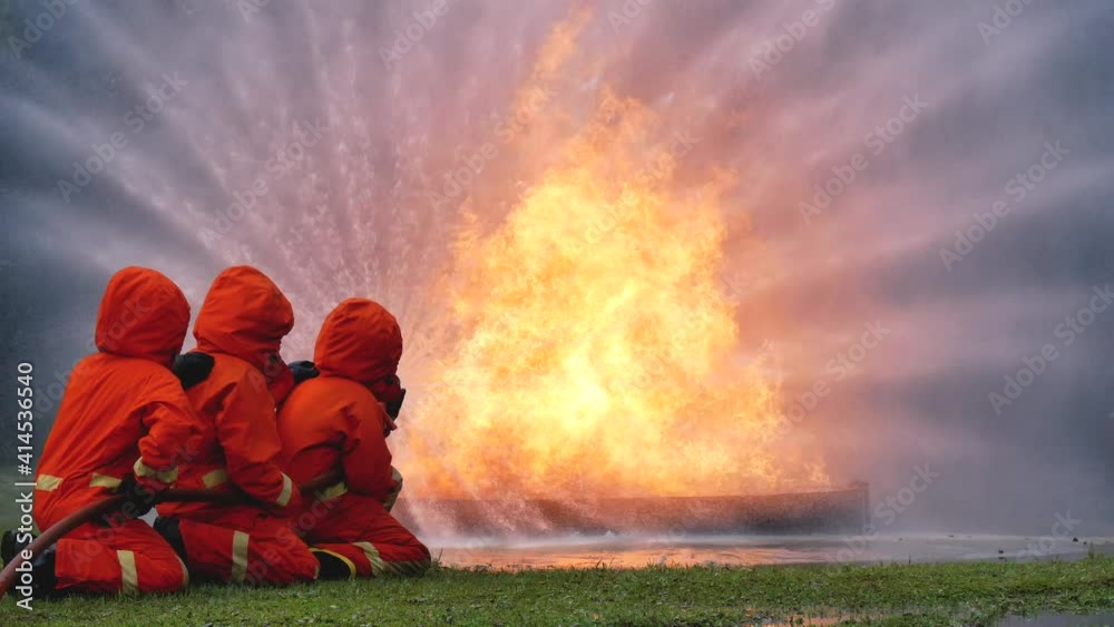 Firefighter fighting with fire flame protection property. Fireman wear ...