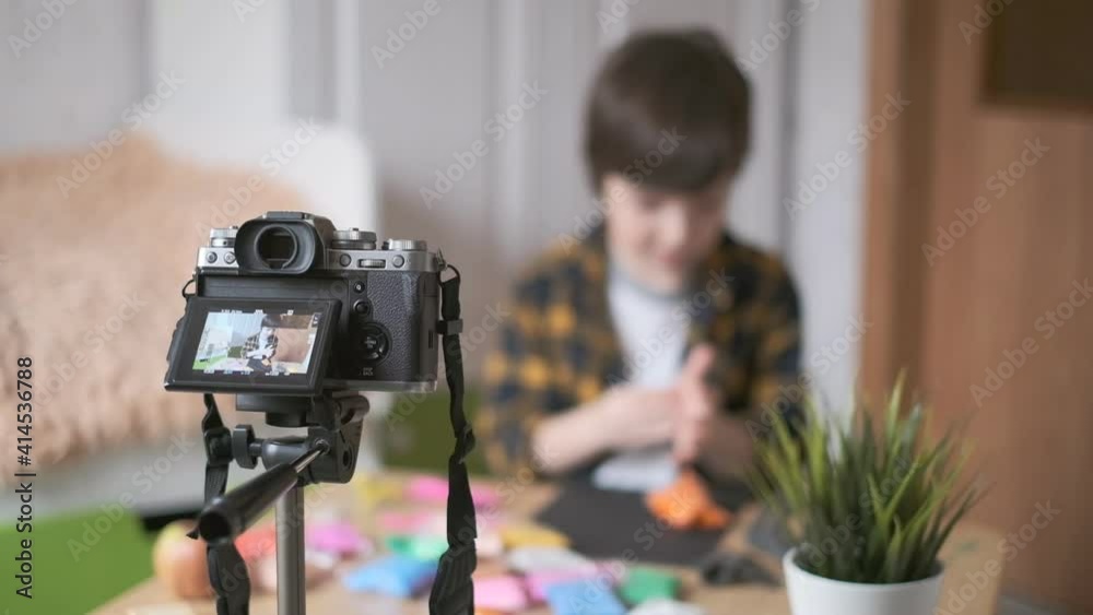 The boy is a vlogger. The boy is recording a vlog for his YouTube ...