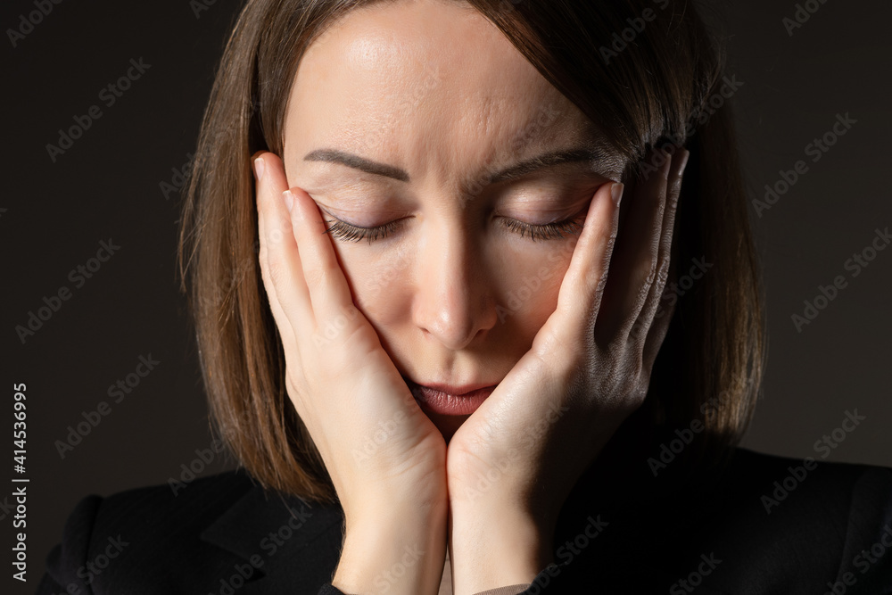 Portrait of a woman in business suit. Sad girl holding face. Concept ...
