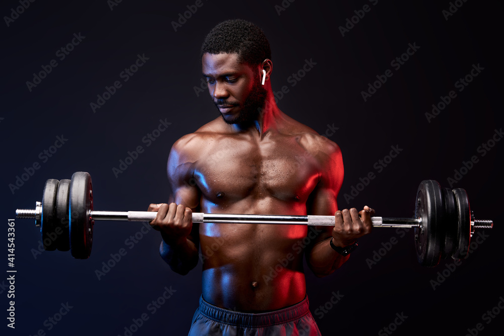 bodybuilder doing heavy weight exercise, using weight, pumping arm ...