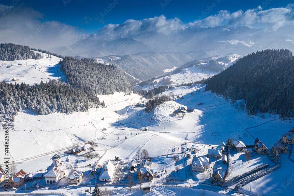 Aerial scenic rural view of the winter landscape from Fundata village ...