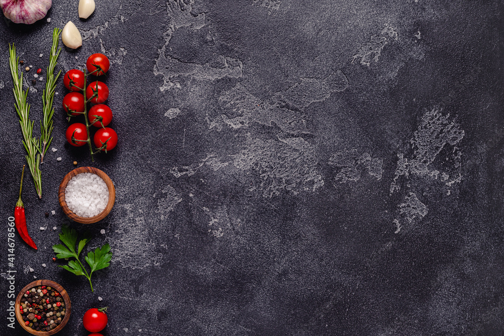 Herbs and condiments on black stone background. Stock Photo | Adobe Stock