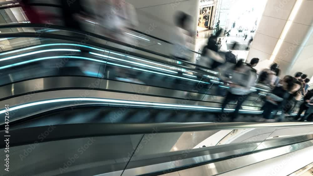 Shopping mall people crowd move on escalator fast with blur motion ...