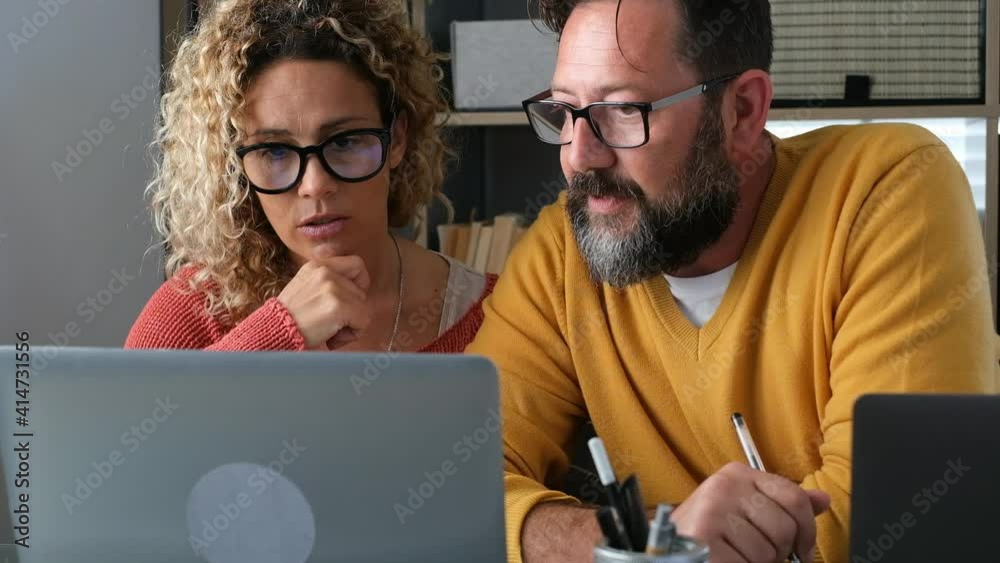 Adult caucasian couple at home in smart working and remote work job ...