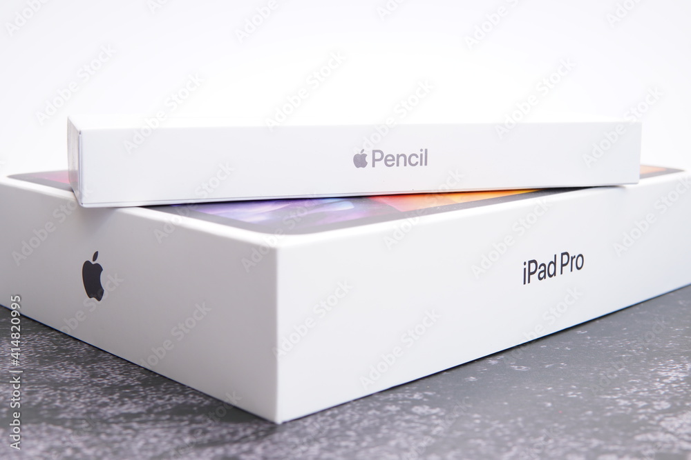 Apple iPad Pro 11 and Apple Pencil 2 unboxing on a grey background. For ...