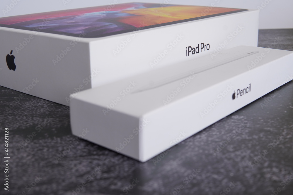 Apple iPad Pro 11 and Apple Pencil 2 unboxing on a grey background. For ...