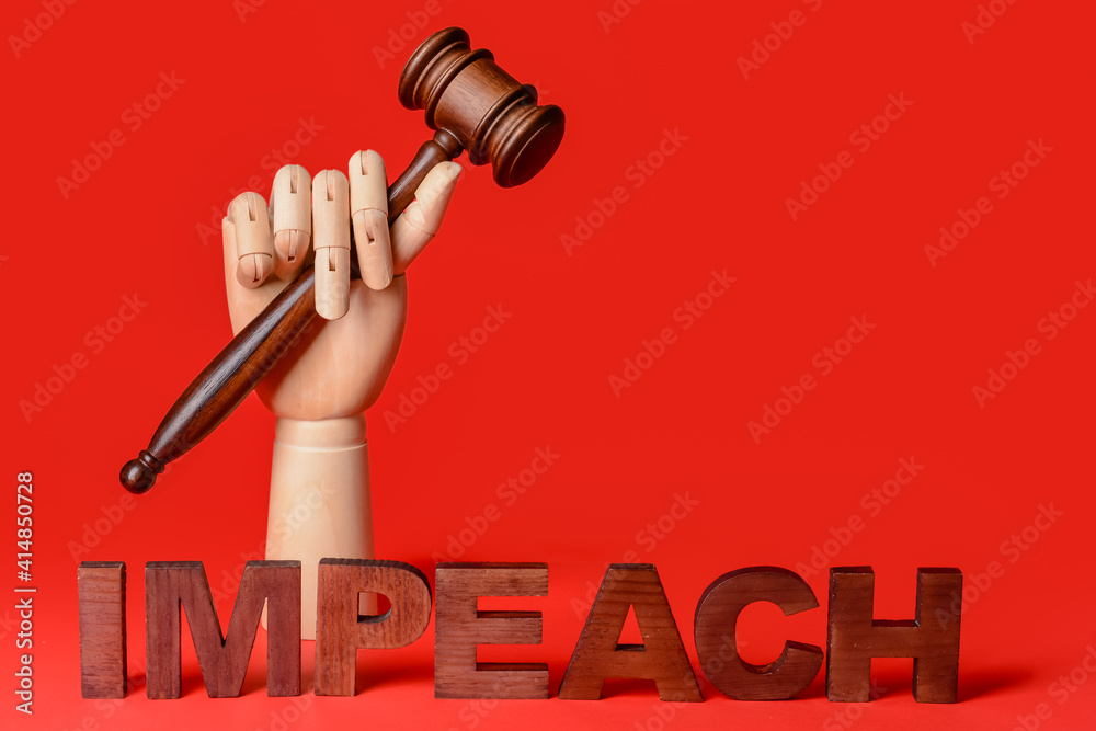 Wooden hand with judge gavel and word IMPEACH on color background Stock ...