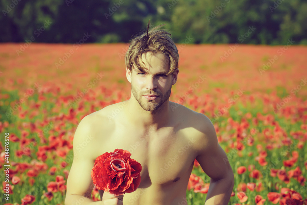 Sexy man with muscular body and athletic torso hold flower bouquet in ...