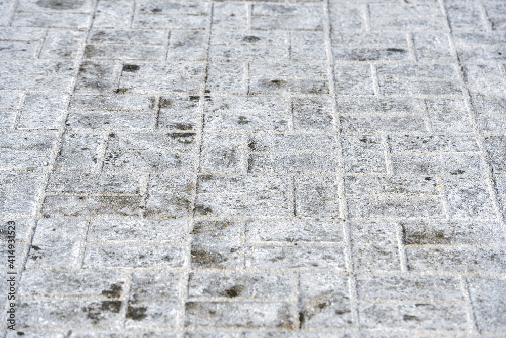 Salty surface, salt on paving slabs outdoors. Rock salt (sodium ...