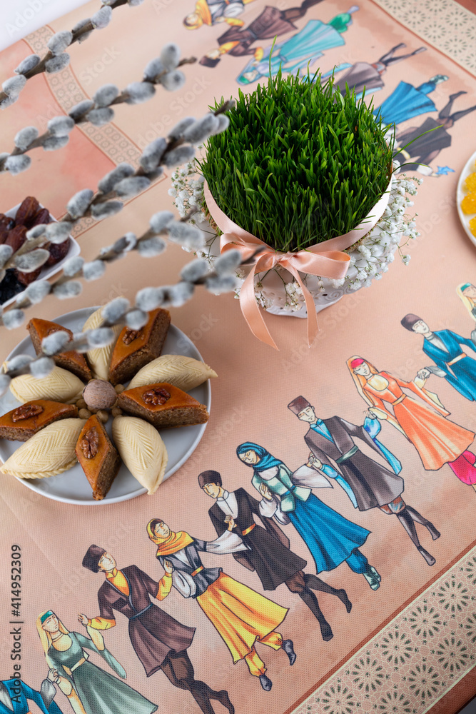 Beautiful Novruz table set up in pastel colors with wheat grass ...
