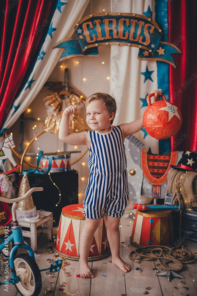 A white boy lifts a circus weight. Stylized circus photo zone. Stock ...