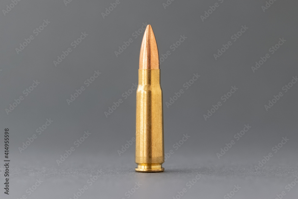 Bullet on gray background. Cartridge 7.62 caliber for Kalashnikov ...