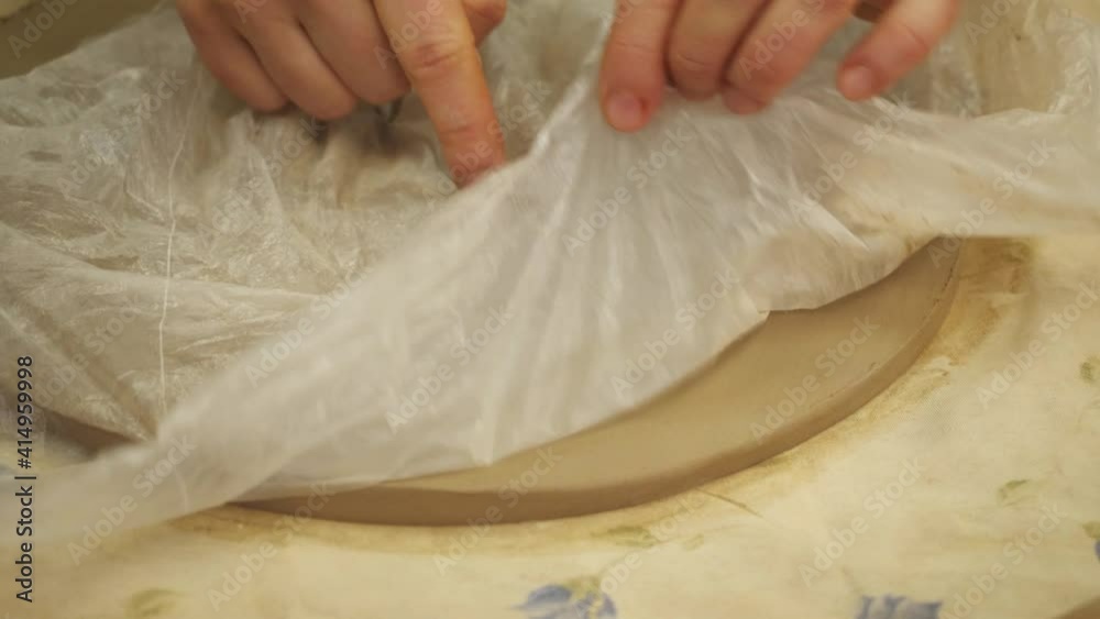 Close-up of the hand of the master, who is using a plastic bag to align ...