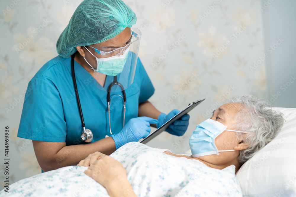 Asian doctor wearing face shield and PPE suit new normal to check ...