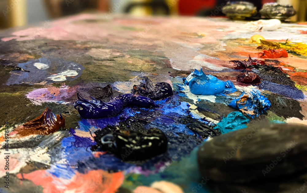 oil paint colors mixed on the palette creating beautiful shapes ...
