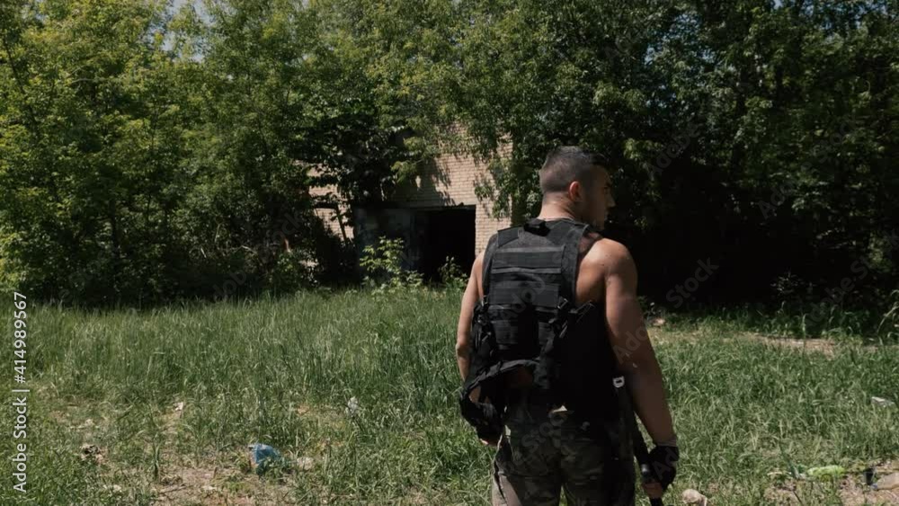 Strong shirtless security guard with strong torso patrolling the ...