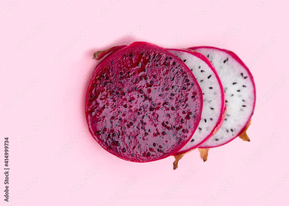 Red and pink dragon fruit slice with red and white flesh. The pitahaya ...