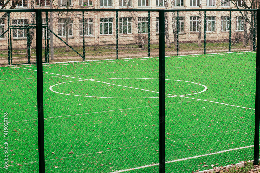 School soccer stadium. Empty soccer field behind the iron fence Stock ...