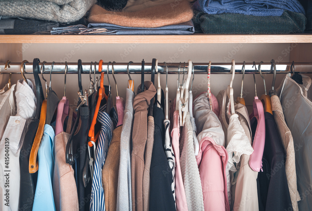 Things on hangers and on a shelf in the closet. Side view, horizontal ...