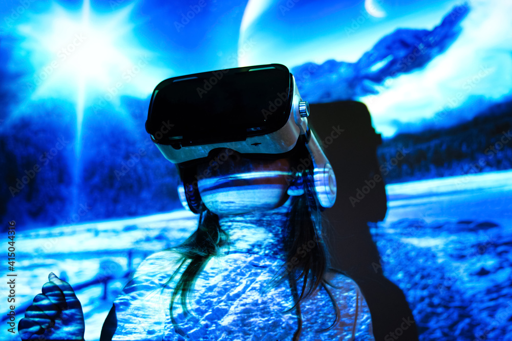 Foto de Unrecognizable young girl in casual wear and VR headset getting ...