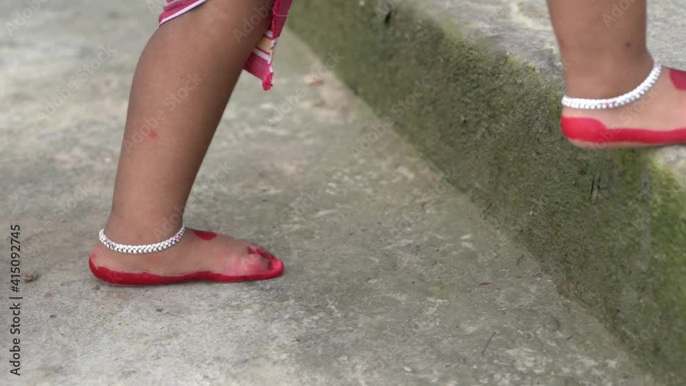 Unrecognized little Indian girl child walking up stairs, closeup shot ...
