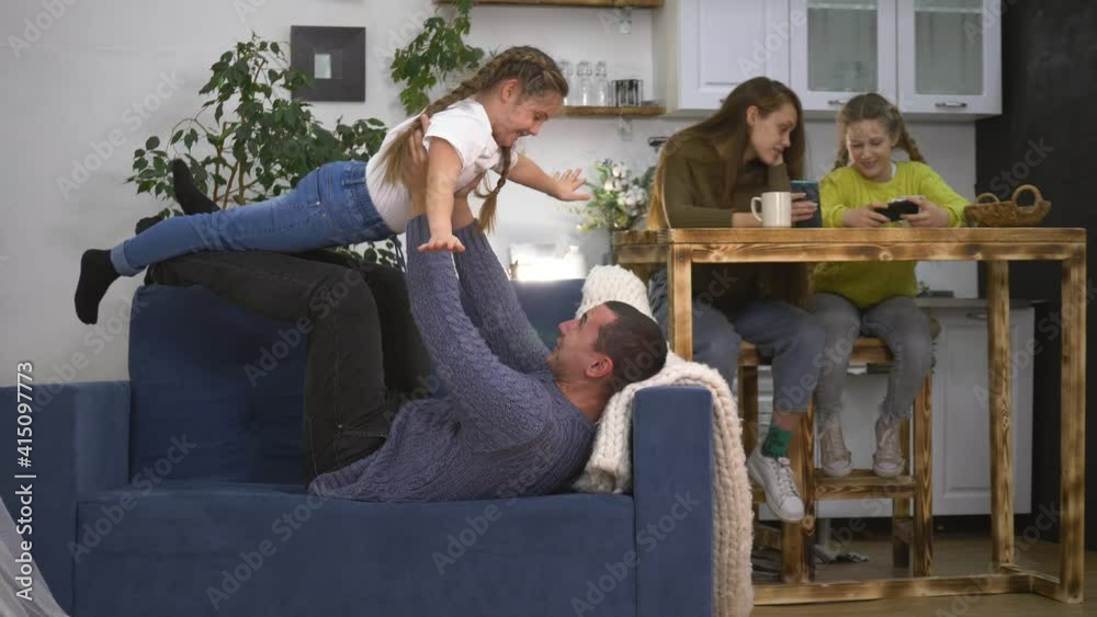 Happy family playing home. Airplane pilot girl. Father and daughters ...