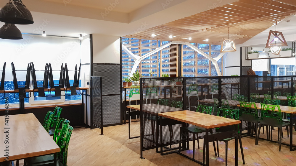 Large cafeteria, no people dining room with lots of wooden tables and ...